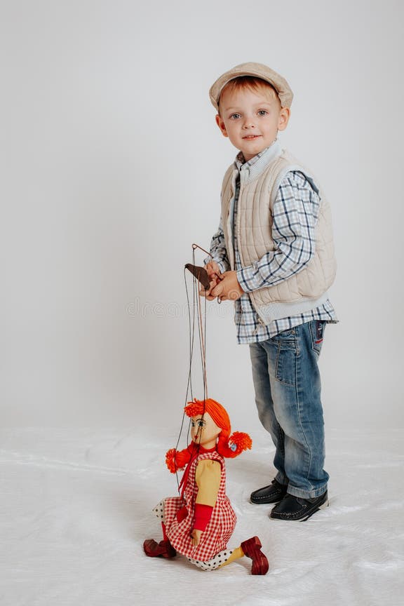 Little Boy in Cap Standing with a Puppet Doll Stock Photo - Image of ...