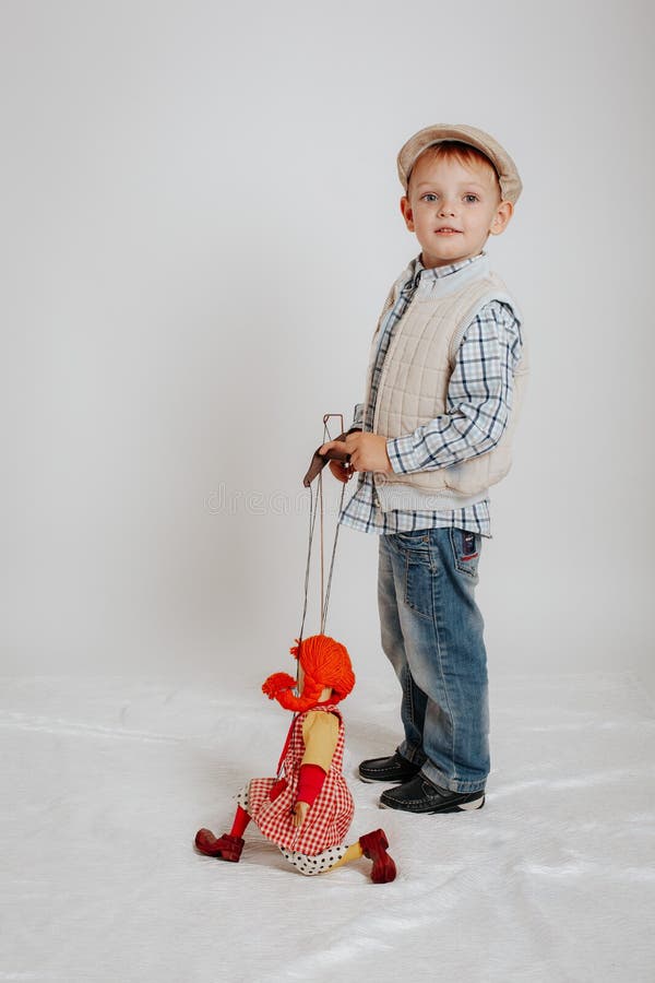 Little Boy in Cap Standing with a Puppet Doll Stock Photo - Image of ...
