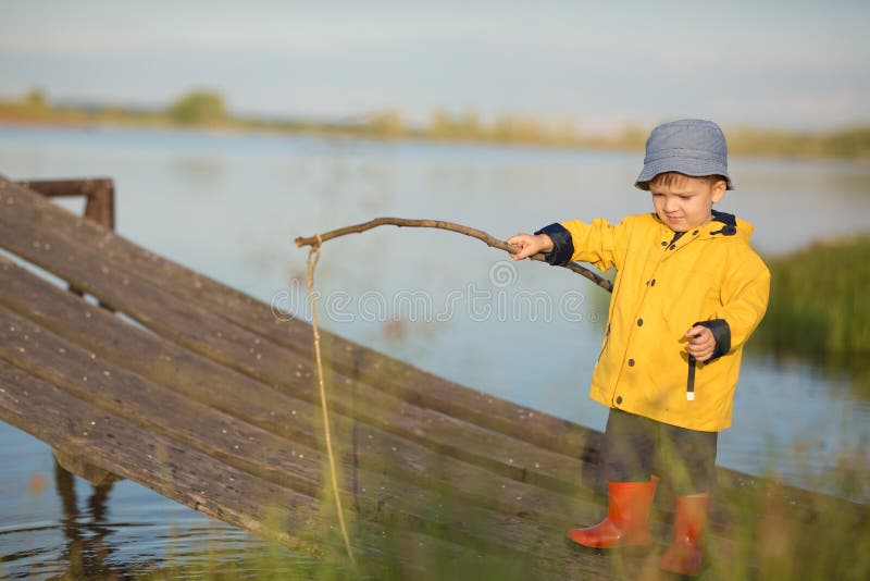 Little Boy Catching a Fish from Wooden Dock Stock Image - Image of ...