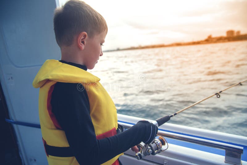 Little Boy Caught Fish Spinning from a Boat at Sea Stock Photo - Image ...