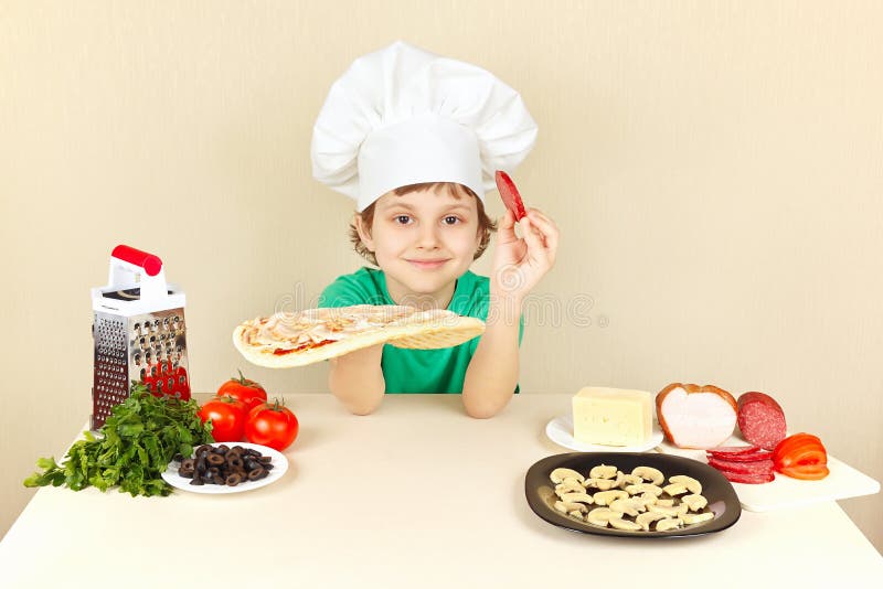 Little Boy in Chefs Hat Puts Sausage on Pizza Crust Stock Image - Image ...