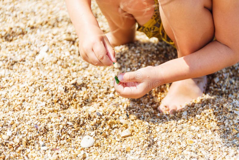 Little Boy Collects Pebbles Stock Image - Image of backgrounds ...