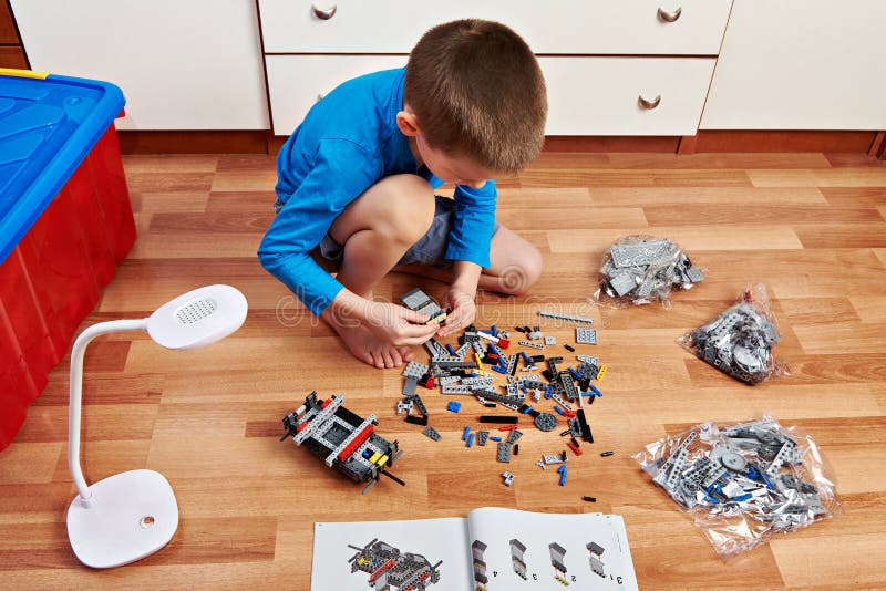Little Boy Collects Plastic Constructor Stock Photo - Image of color ...