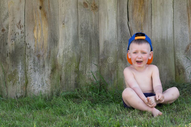 Little Boy is Crying Alone in the Grass Stock Photo - Image of copy ...