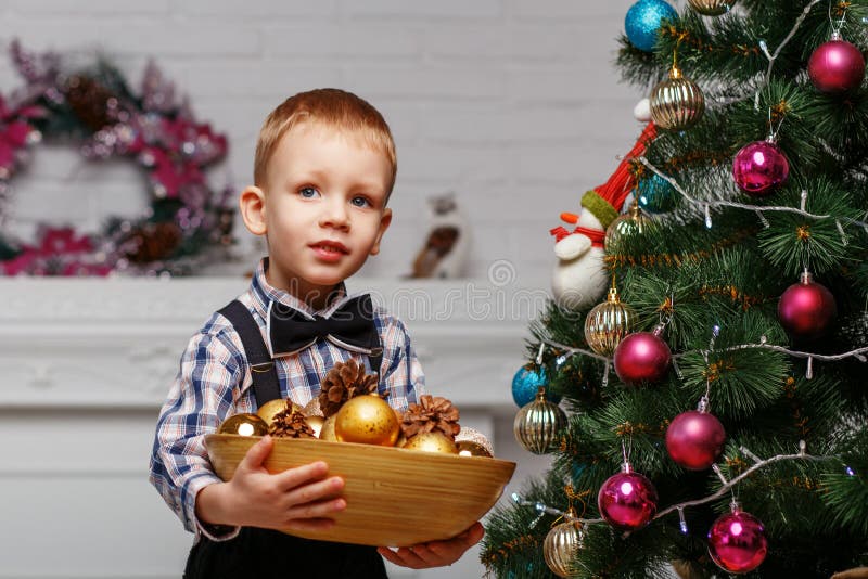 Little Boy Decorates a Christmas Tree in the Interior with Chris Stock ...
