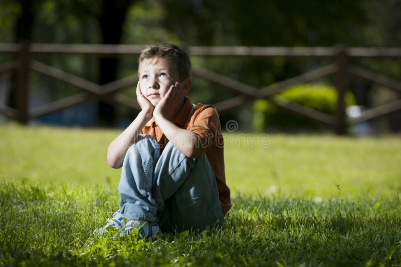 Little Boy Deep in Thoughts Stock Image - Image of outdoors, children ...