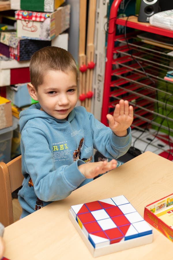 A Little Boy at a Desk Assembles a Letter from Blocks. Overall ...