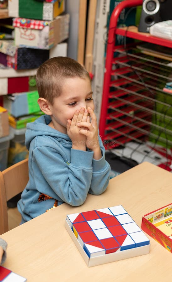 A Little Boy at a Desk Assembles a Letter from Blocks. Overall ...