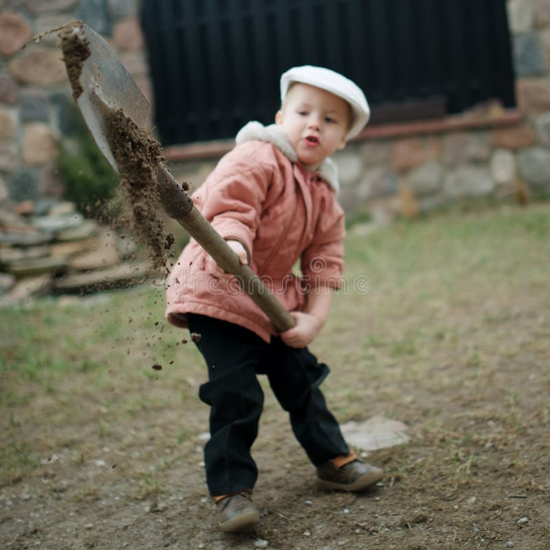 Little boy digging a hole stock photo. Image of outside - 58070562