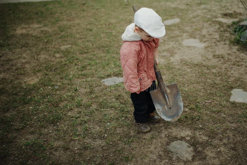 Little boy digging a hole stock image. Image of grow - 58070533