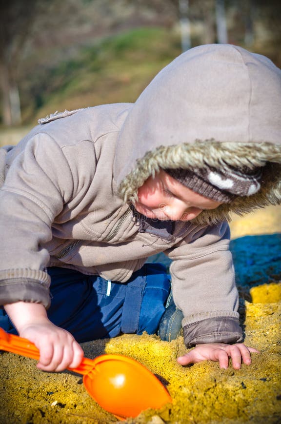 Little boy digs in sand stock photo. Image of playful - 23073624