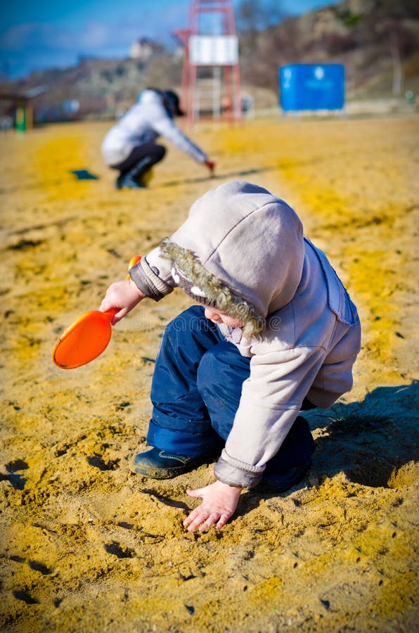 Little boy digs in sand stock image. Image of blur, outdoors - 23073707