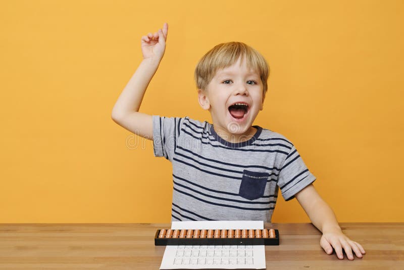 Little Boy Doing Simple Math Exercises with Abacus Scores. Mental ...