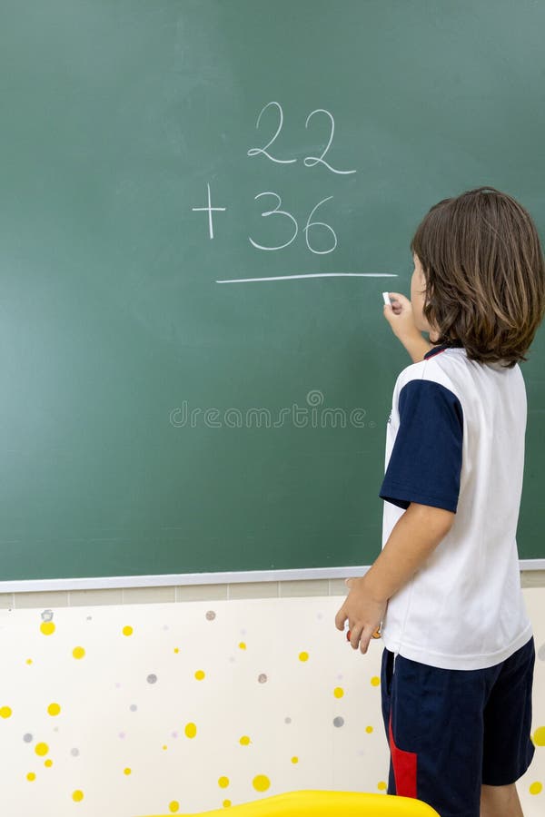 Little Boy Doing Sums on the Blackboard at School Stock Photo - Image ...