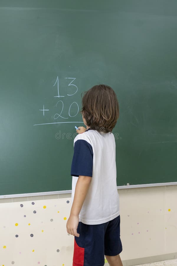 Little Boy Doing Sums on the Blackboard at School Stock Image - Image ...