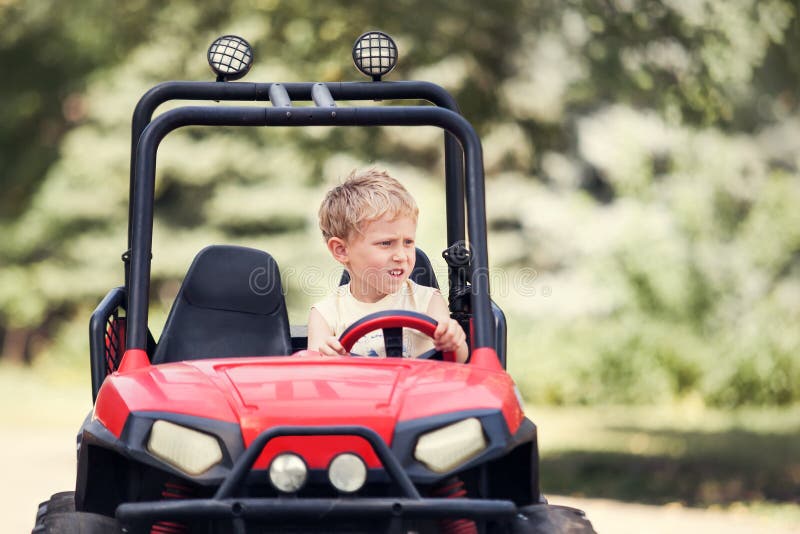Little Boy Drive a Mini Electric Car in Park Stock Photo - Image of ...