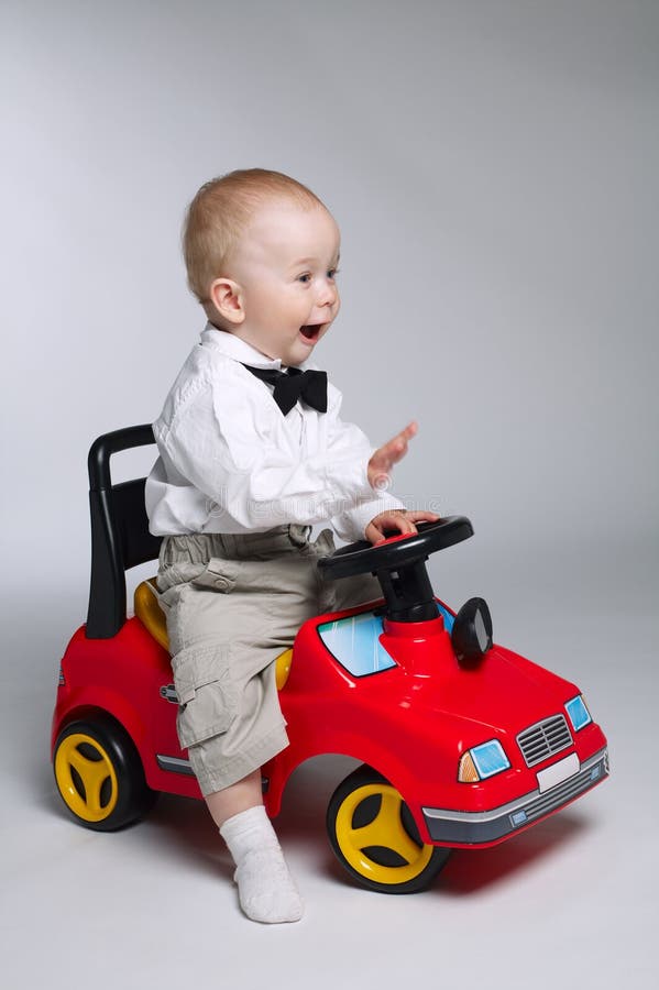 Little boy driving toy car stock image. Image of isolated - 80378939
