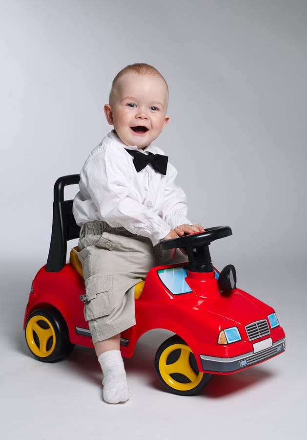 Little boy driving toy car stock image. Image of studio - 80378959