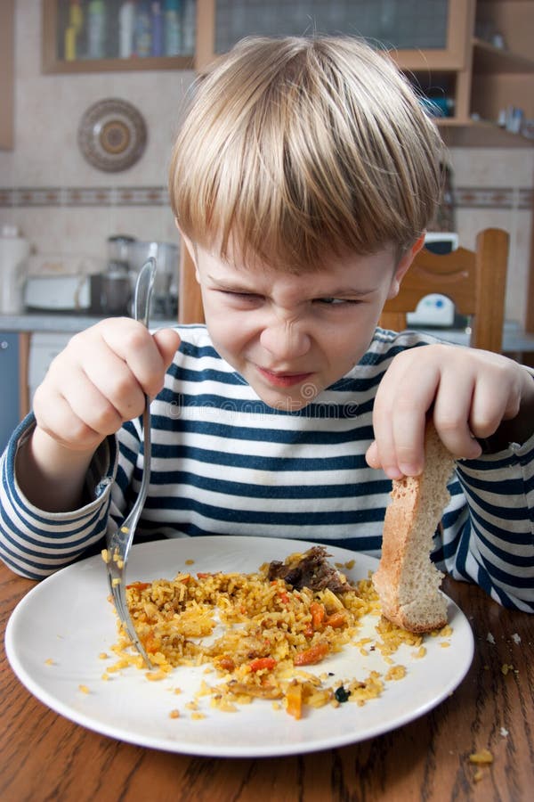 Little boy eating stock image. Image of dinner, holding - 12181843