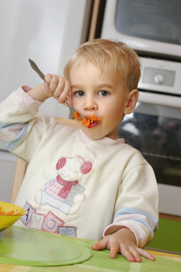 Little boy eating stock image. Image of dirty, kitchen - 4149041