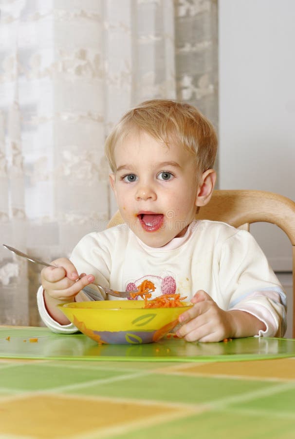 Little boy eating stock photo. Image of kitchen, mouth - 4149052