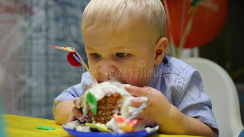 Little Boy Eating Cake with Cream on a Festive Stock Video - Video of ...