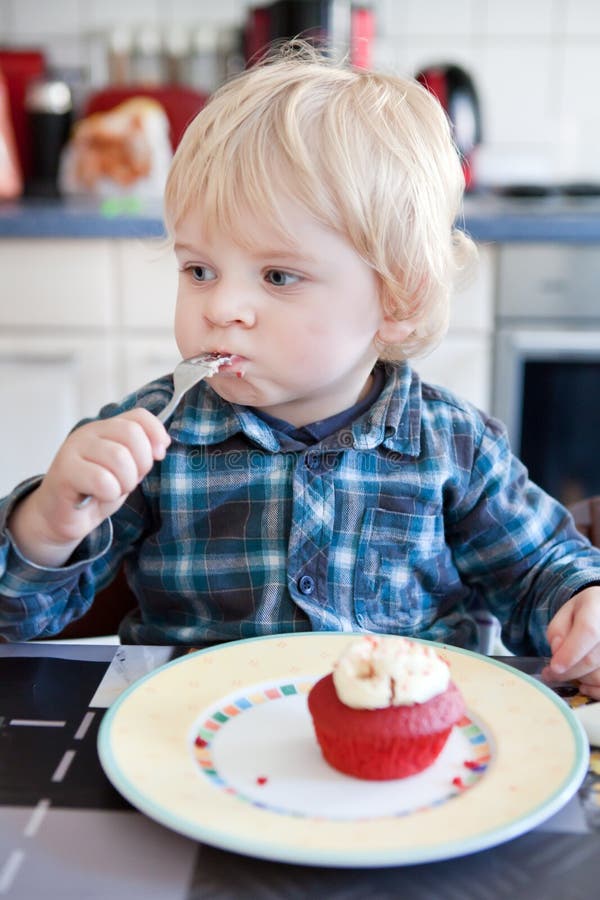 Little Boy Eating Red Cupcake Stock Image - Image of sweet, beautiful ...