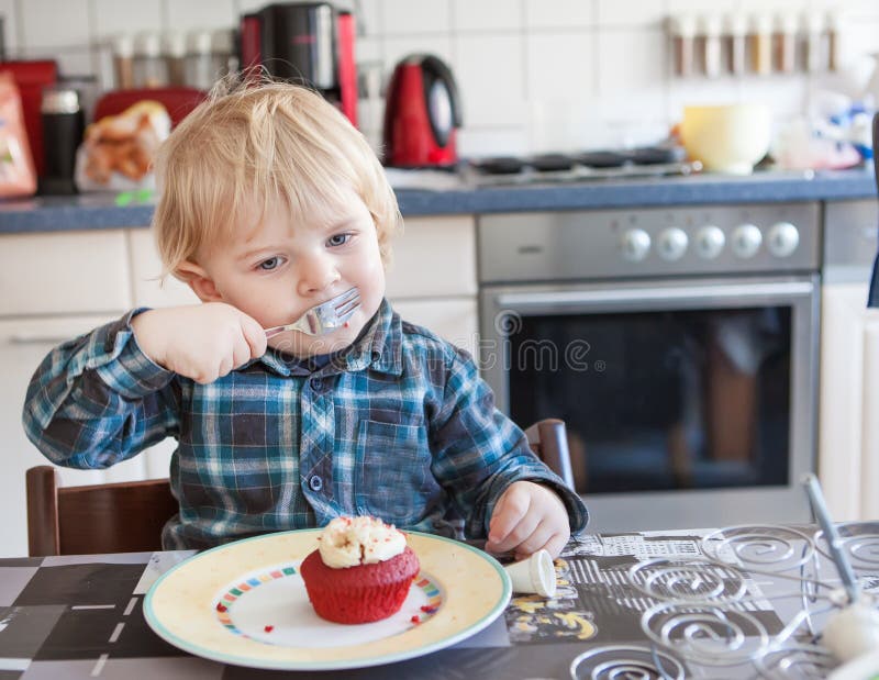 Little Boy Eating Red Cupcake Stock Image - Image of baby, person: 28154569