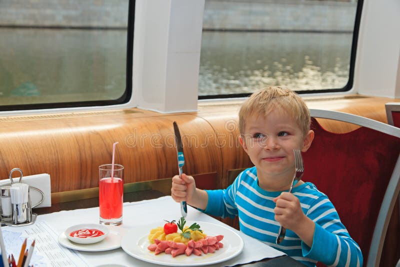 Little Boy Eating in Restaurant Stock Image - Image of food, meal: 56153973