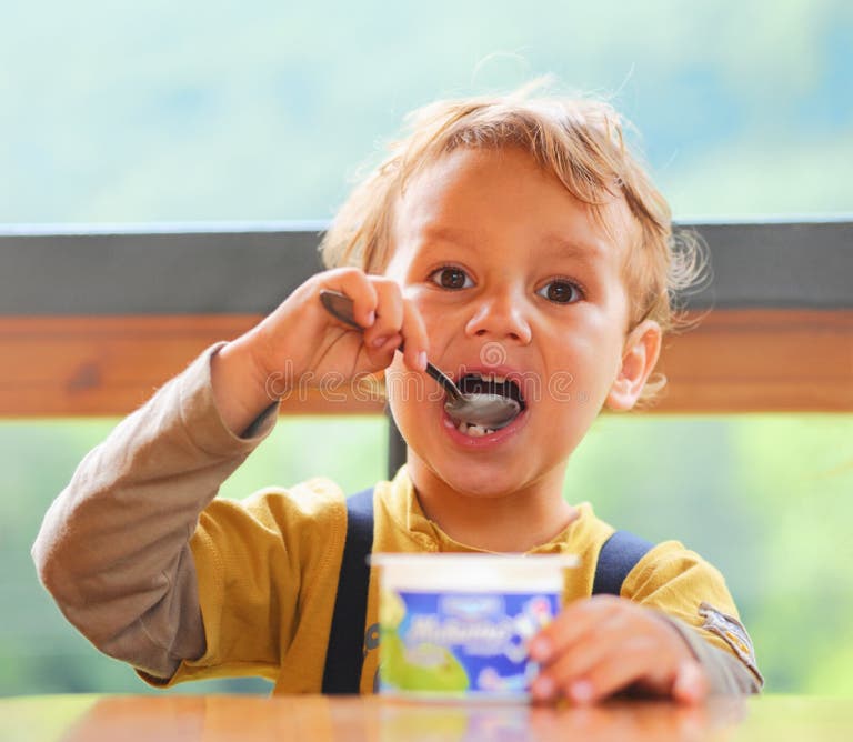 Little Boy is Eating Yogurt. Stock Image - Image of human, snack: 12618603