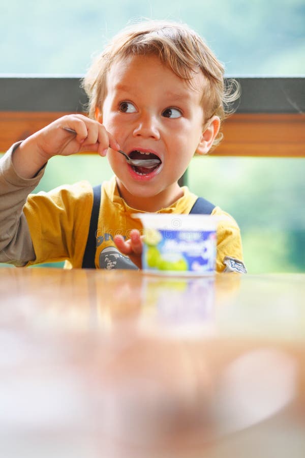 Little Boy is Eating Yogurt. Stock Image - Image of human, snack: 12618603