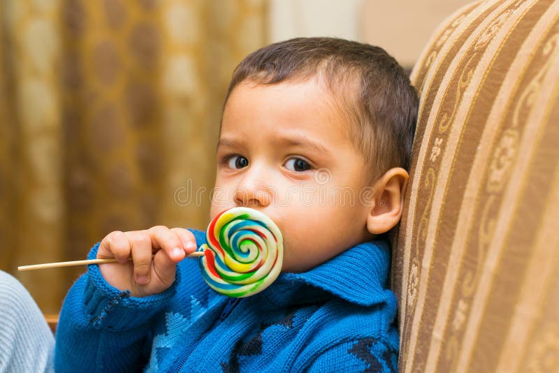 Little boy eats candy stock image. Image of person, funny - 64961513