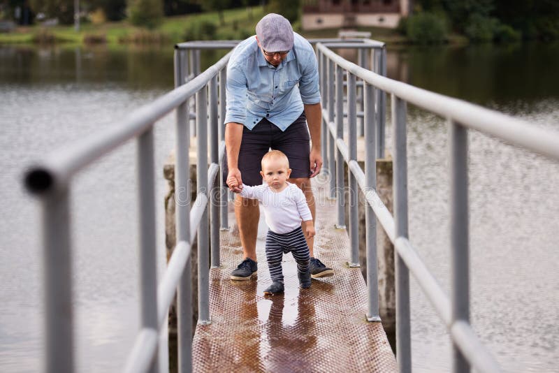 Little Boy with Father Making First Steps in Nature. Stock Photo ... Little Boy with Father Making First Steps in Nature. Stock Photo ...