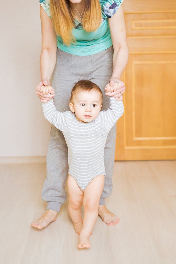Little Boy First Steps with the Help of Mother Stock Image - Image of ...