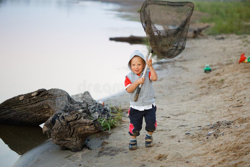 Little Boy Fishing with a Net for Fish Stock Image - Image of life ...
