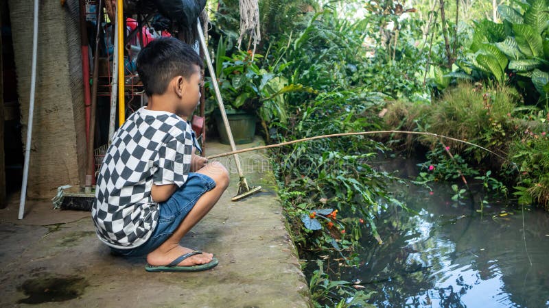 A Little Boy is Fishing in the Pond Stock Image - Image of holding ...