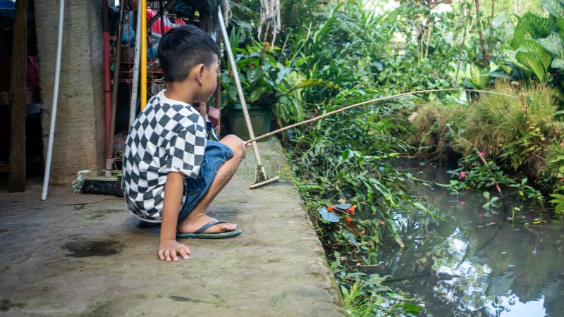 A Little Boy is Fishing in the Pond Stock Image - Image of leisure ...