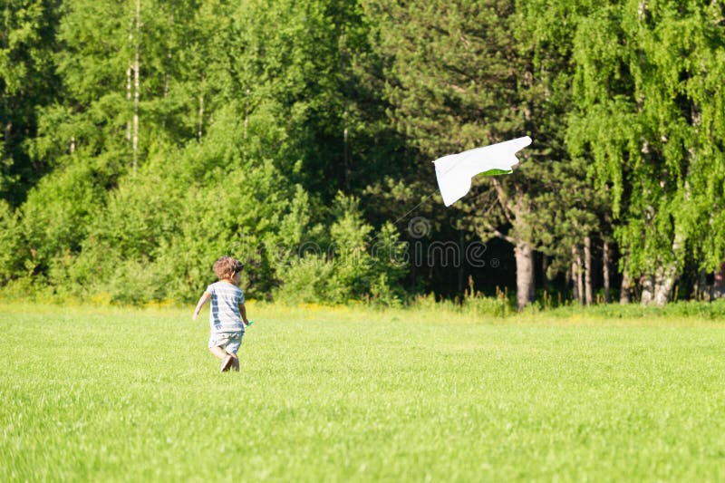 Little boy flying a kite stock photo. Image of little - 223831108