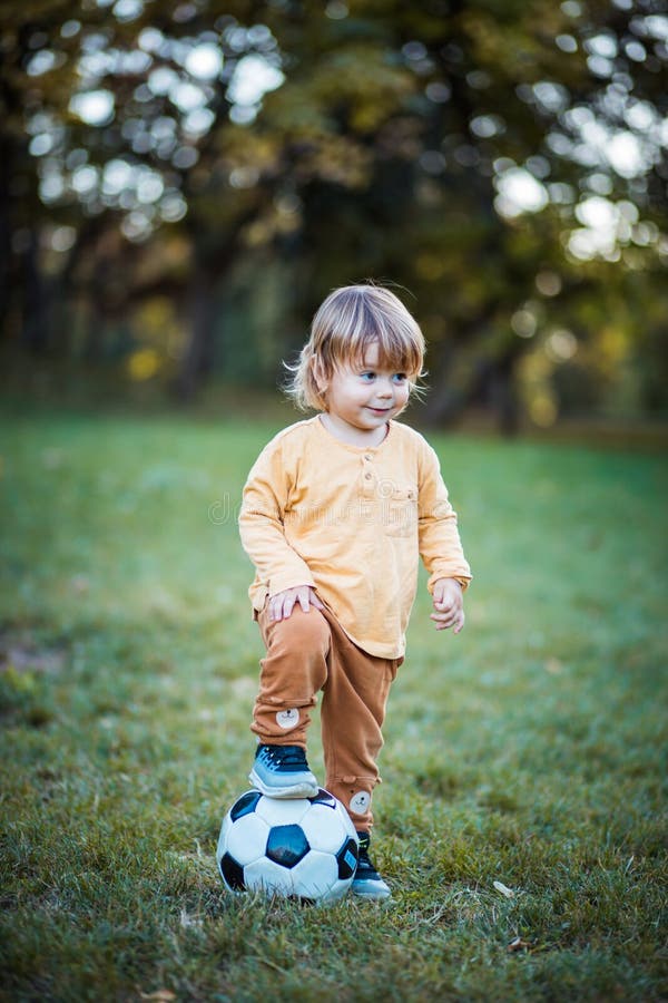 Little Boy with Football Ball on Grass Stock Photo - Image of toddler ...