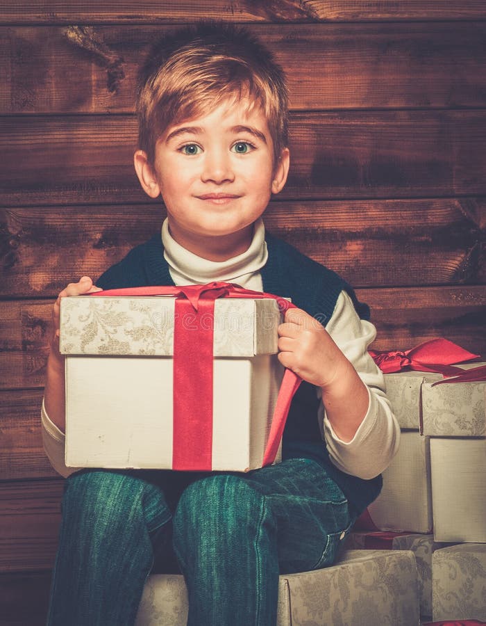 Little Boy with Gift Box in Wooden House Interior Stock Photo - Image ...