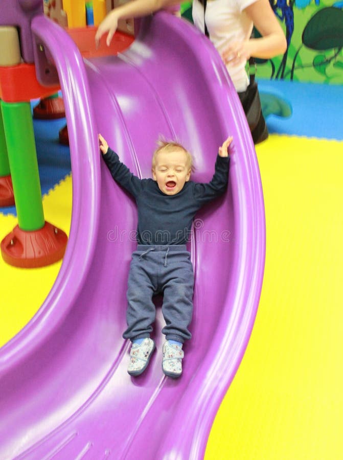 Little boy goes on a slide stock photo. Image of children - 53766080