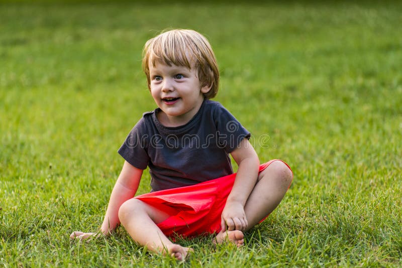 Little boy on grass stock photo. Image of cute, childhood - 77064112