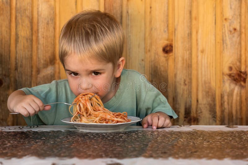 A Little Boy is Greedy Eating Spaghetti Stock Photo - Image of ...