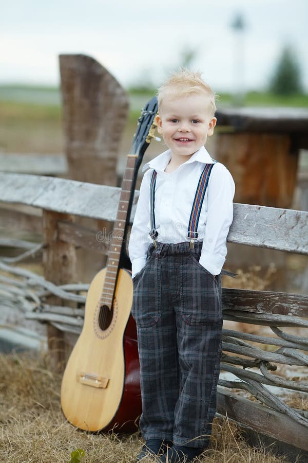 Little Boy with Guitar on Location Stock Image - Image of musician ...