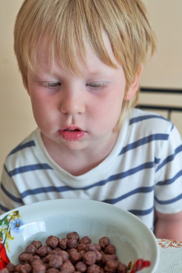 Little Boy is Having Breakfast with Chocolate Balls with Milk Stock ...