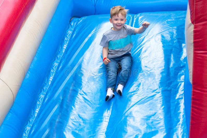 Little Boy Having Fun on the Slide in the Fun Park Stock Photo - Image ...