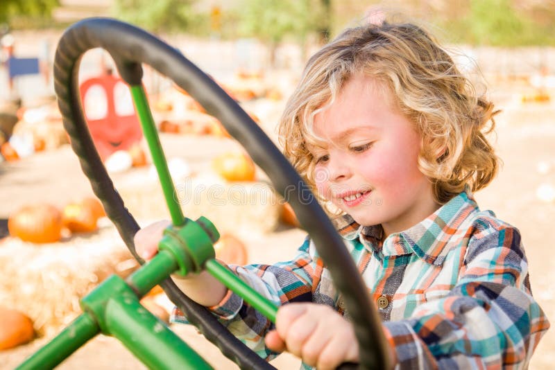 Little Boy Having Fun on a Tractor in a Rustic Ranch Setting at the ...