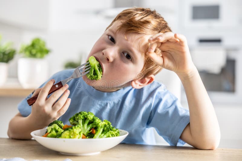 A Little Boy is Having Lunch and Eating Broccoli Stock Photo - Image of ...
