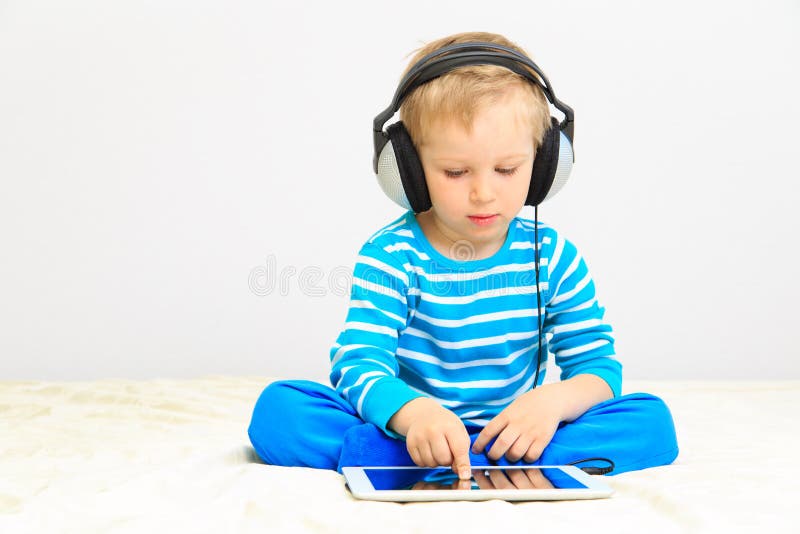 Little Boy with Headset Using Touch Pad Stock Image - Image of playing ...