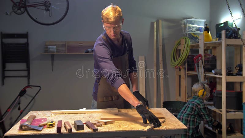 Boy Helps To Put Tools on the Shelf in the Workshop Stock Image - Image ...